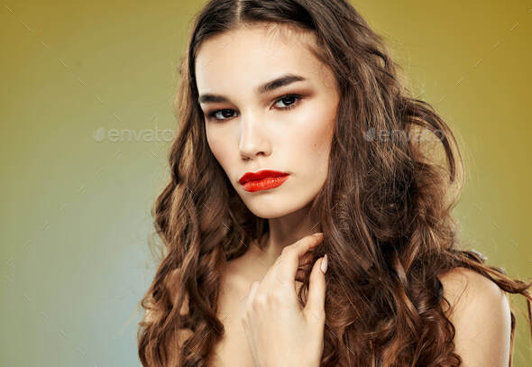 Woman on a dim background with long hair and red lips model makeup ...