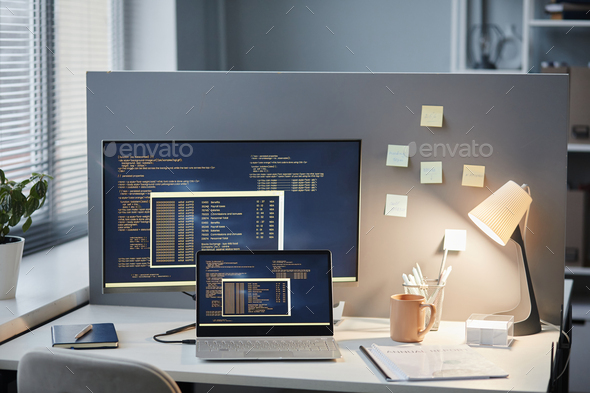 Office Workplace Setting with Code Lines on Computer Screens Stock ...