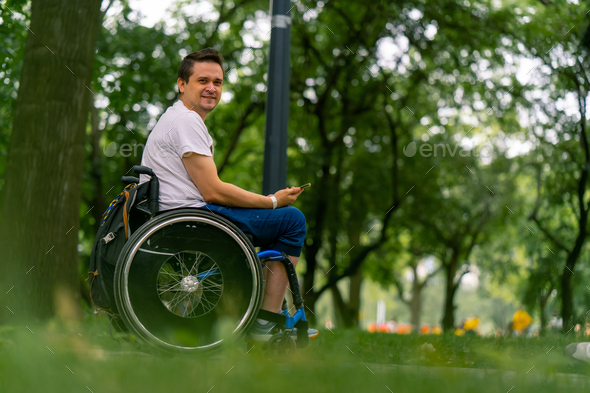 Focused A man with disabilities in a wheelchair stares into a ...