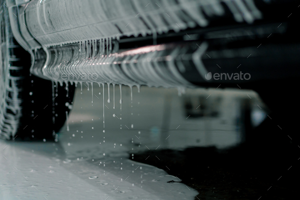 A close-up of car foam on the door sills of a black luxury car in ...