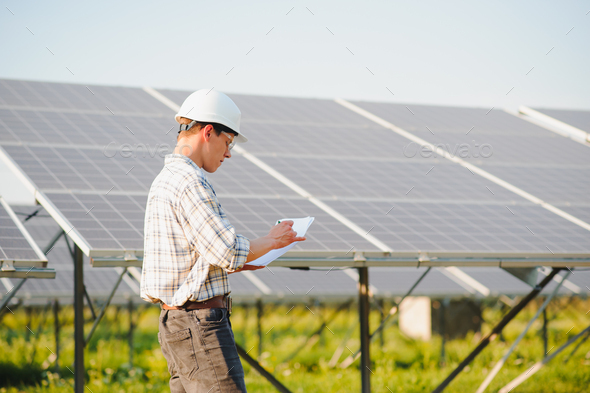The portrait of a young engineer checks photovoltaic solar panels Stock ...