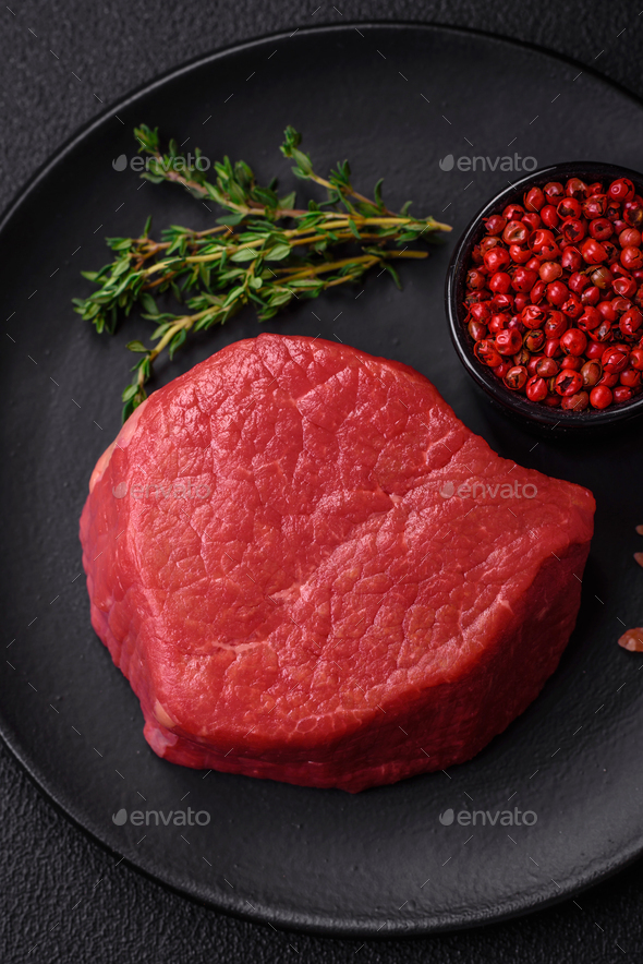 Fresh juicy raw filet mignon with salt, spices and herbs Stock Photo by ...
