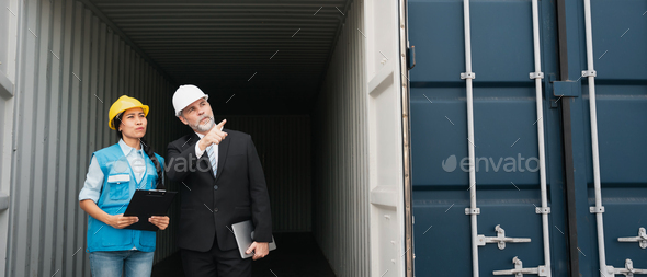 Engineer or foreman checking inside cargo container at a harbor. Stock Photo by NewJadsada