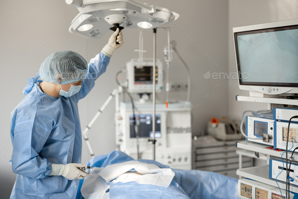 Surgeon prepares to operate a patient in operating room Stock Photo by ...