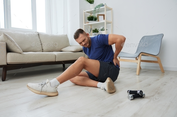 Man athlete pain and injury back arm and leg at home, sports injury ...