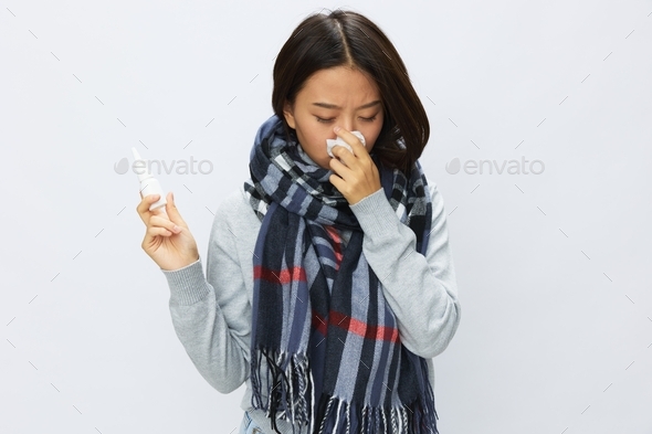 Asian woman holding hand at sore head flu cold with stuffy nose holding ...