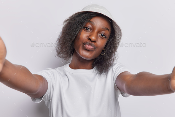 Give me hug. Pretty dark skinned young woman keeps arms outstreched for ...