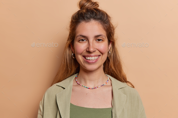 Portrait of nice cheerful European woman smiles happily and looks at ...