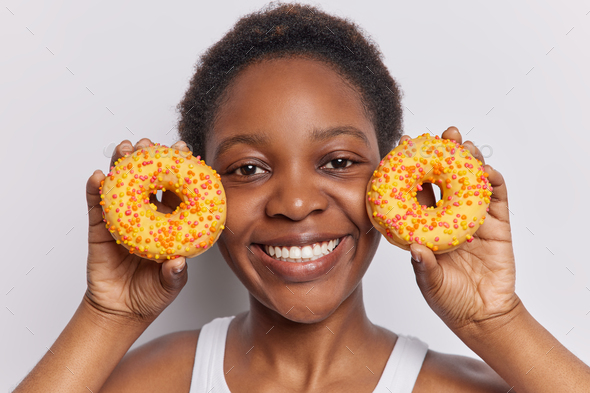 Horizontal shot of dark skinned woman smiles broadly shows white teeth ...