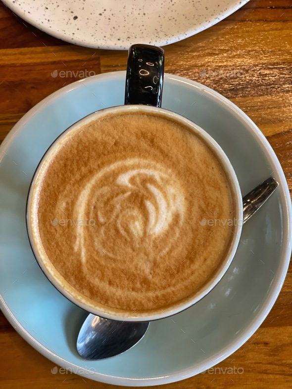 Cappuccino it's a mix between coffee and milk. Draw an artistic pattern ...