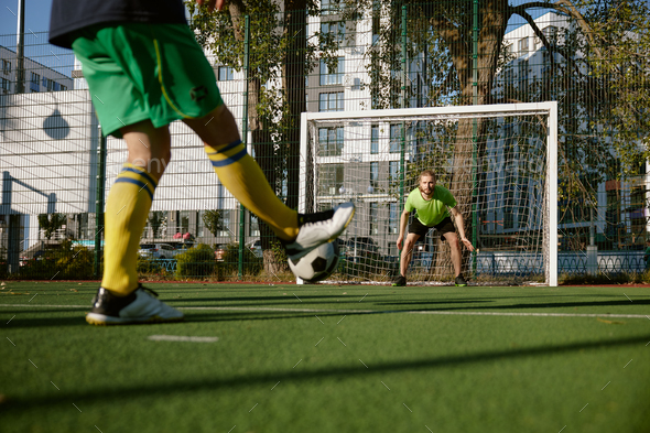 Football player aiming soccer ball trying to score goal Stock Photo by ...