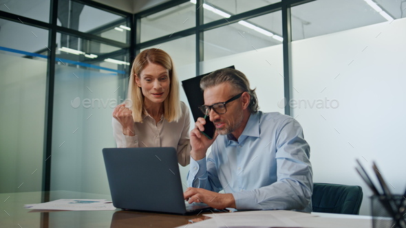 Excited partners celebrating victory in office. Successful coworkers ...