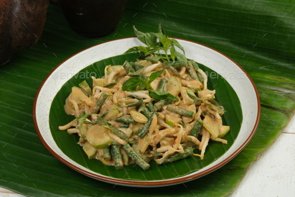 Karedok or keredok is raw vegetables salad covered in spicy peanut ...