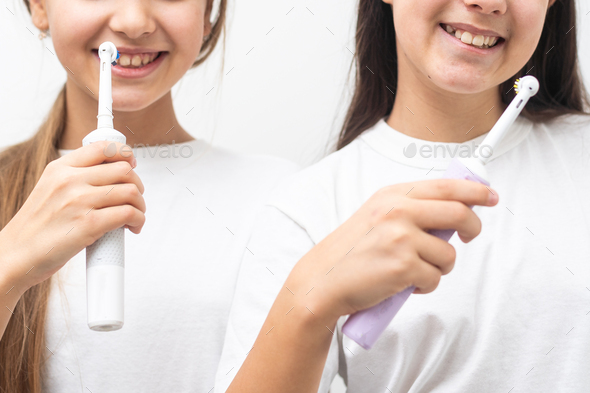 Portrait of two beautiful girls kids with perfect smile holding ...