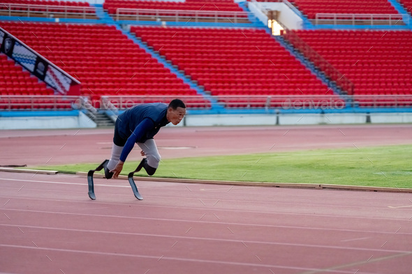 Asian para-athletes with prosthetic blades sprint on a running track at ...