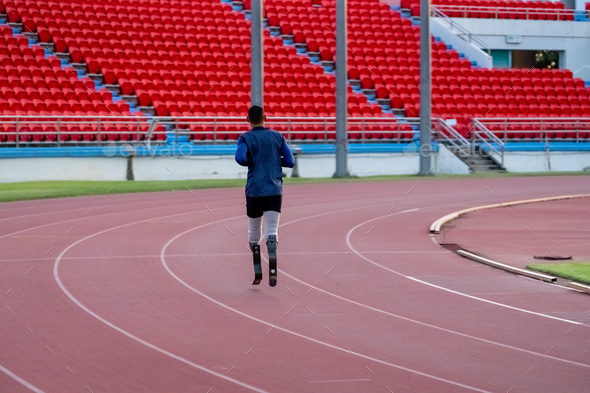 Asian para-athletes with prosthetic blades sprint on a running track at ...