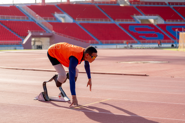 Asian para-athletes with prosthetic blades sprint on a running track at ...