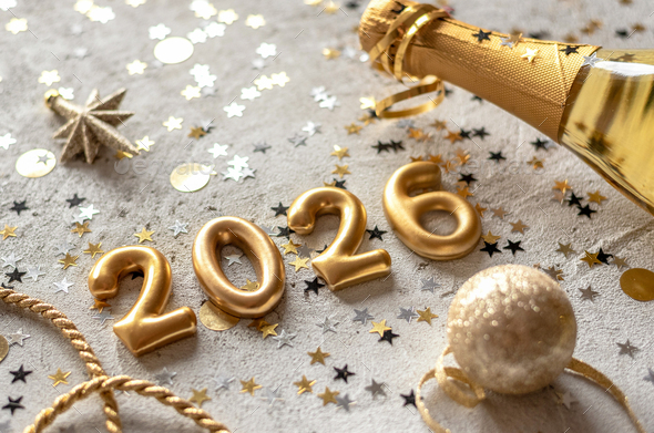 Golden 2026 new year numbers with confetti and champagne bottle Stock ...