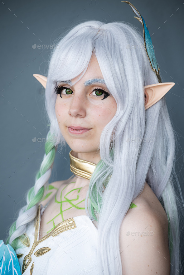 Caucasian female cosplayer dressed as an anime character in a white ...