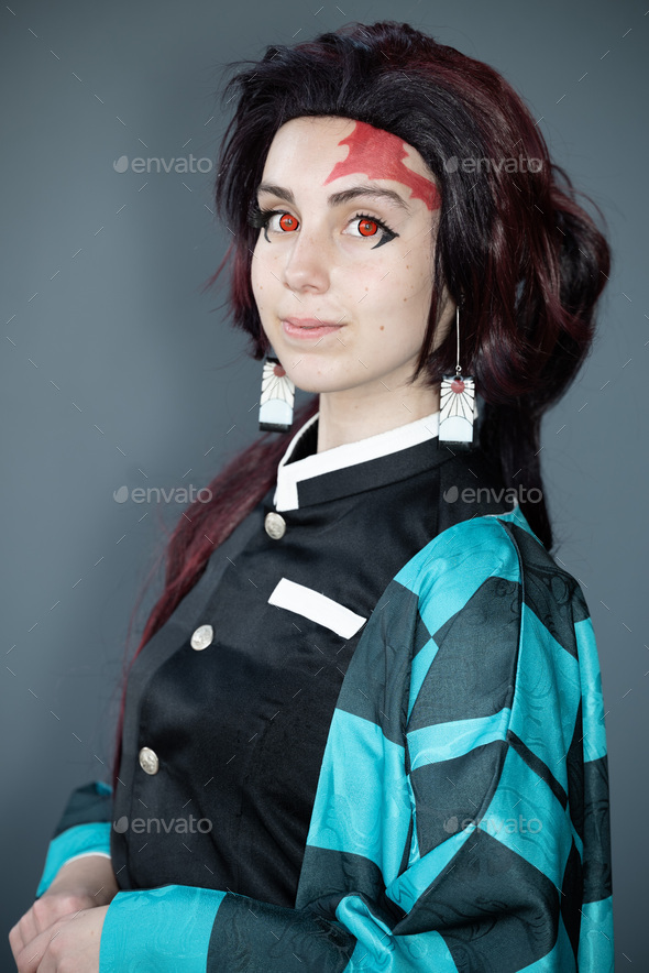 Caucasian female cosplayer in a blue costume with face paint and red ...