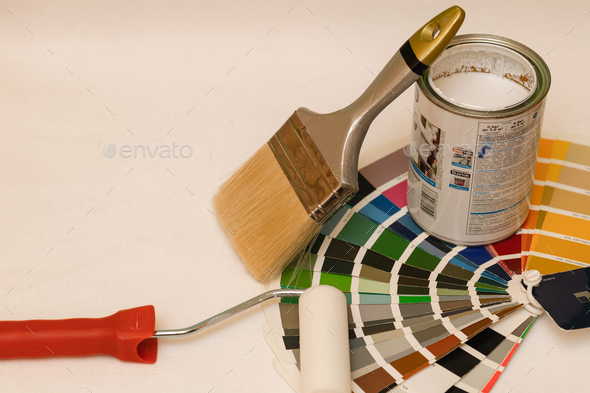 Composition Roller, brush, open can of paint, color palette. Copy space ...
