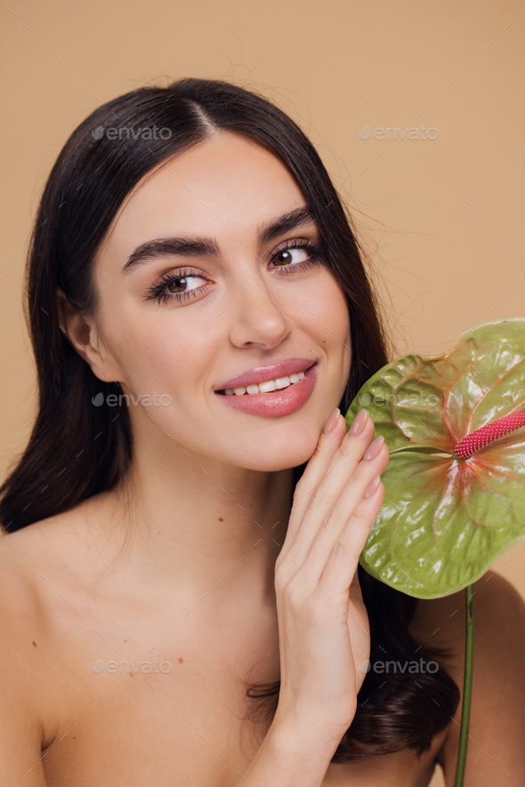 Beauty portrait of attractive young naked woman posing with flower Stock Photo by anatoliycherkas