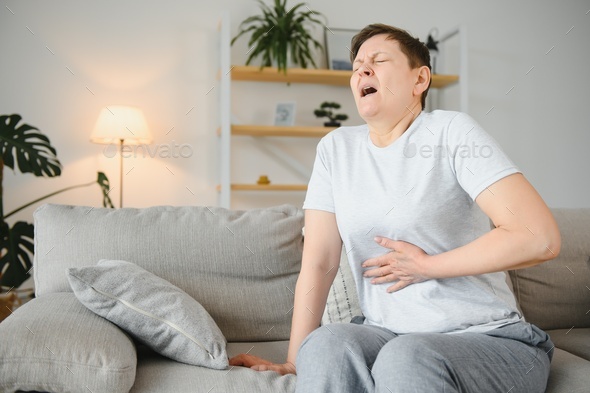 woman sitting on bed feels unhealthy touch stomach suffers from severe ...