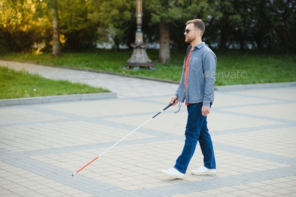 Blind Man Walking On Sidewalk Holding Stick Stock Photo by sedrik2007