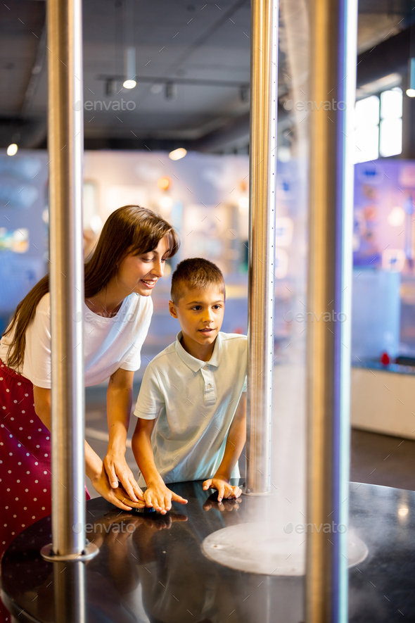 Mom with boy visit a science museum Stock Photo by RossHelen | PhotoDune