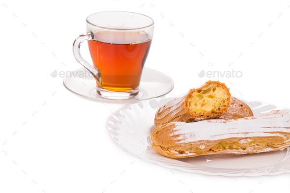 Cup of tea with eclairs Stock Photo by indigolotos | PhotoDune