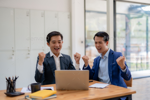 Excited asian businessman team celebrating victory together in office ...