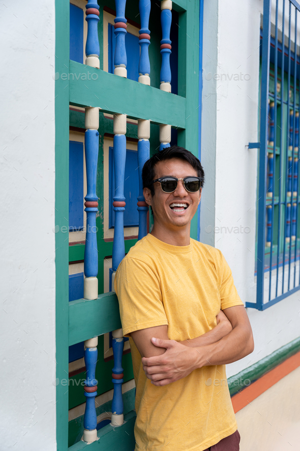 Young Japanese Man Smiling Against a Colorful Door. Portrait Stock ...