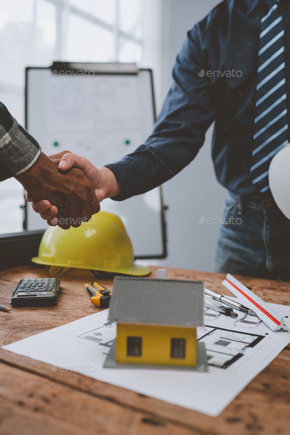 Architects and engineers working together and handshake business ...
