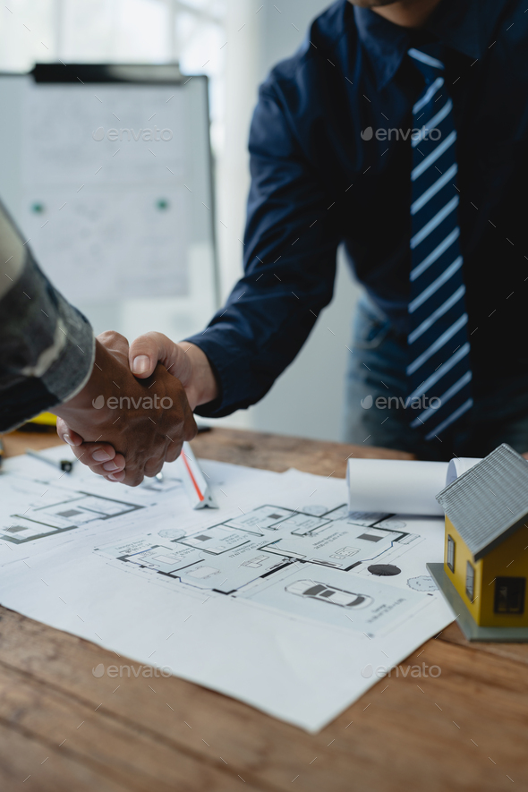 Architects and engineers working together and handshake business ...