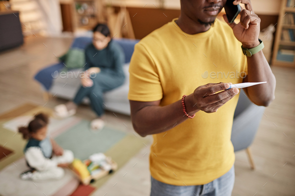 Concerned Father Calling Pediatrician Stock Photo by seventyfourimages