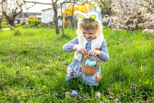 Playful Easter traditions. happy child engages in an egg hunt Stock ...
