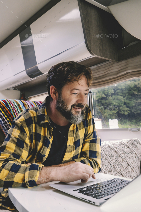 Alternative nomad lifestyle office workstation people. Man working on ...