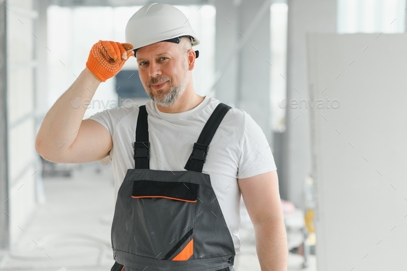 Man Builder. Architect is standing in building. Portrait of thinking ...