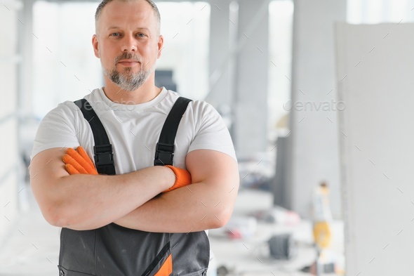 Man Builder. Architect is standing in building. Portrait of thinking ...