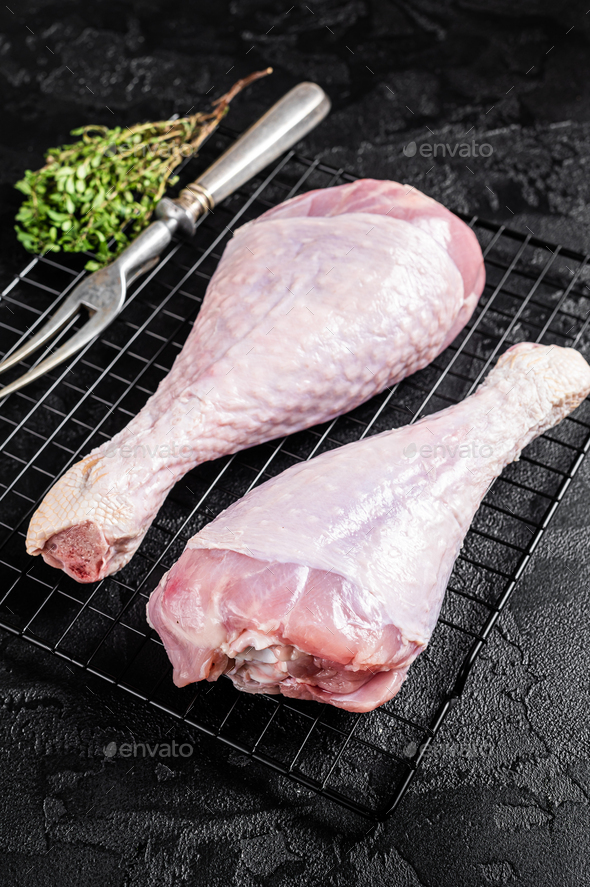 Raw turkey legs on a butcher table. Black background. Top view Stock ...