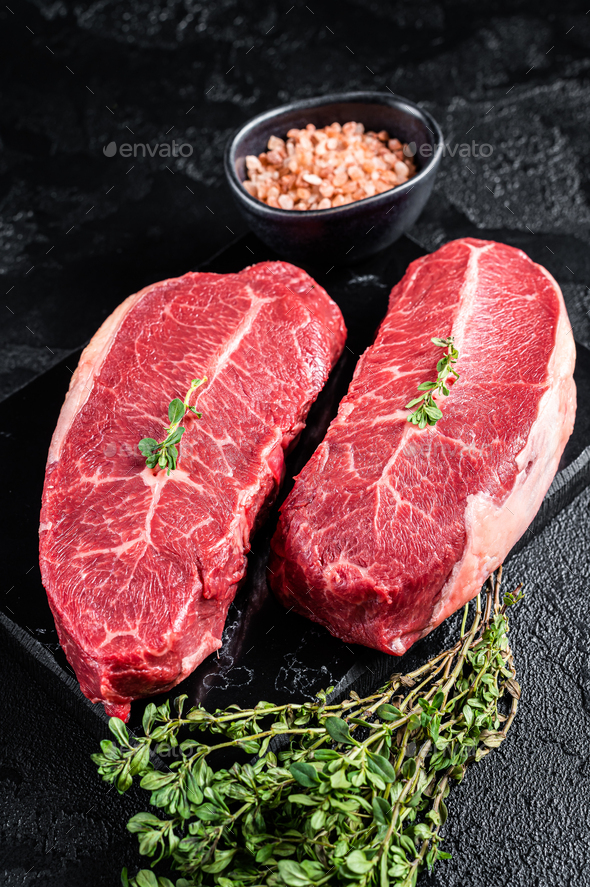 Raw wagyu oyster top blade steaks, organic beef meat. Black background ...