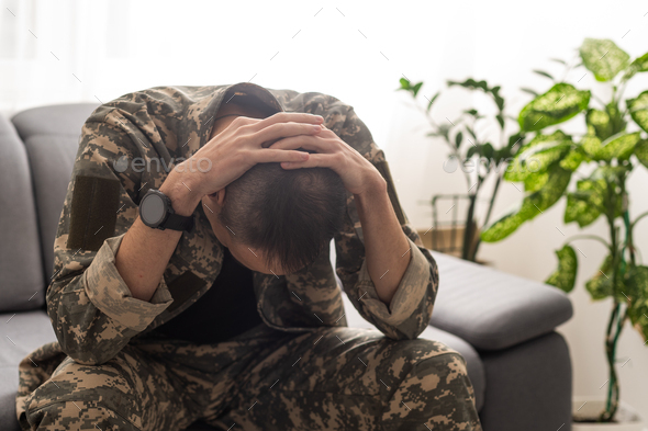 A distraught soldier covering his face, possibly suffering from shell ...
