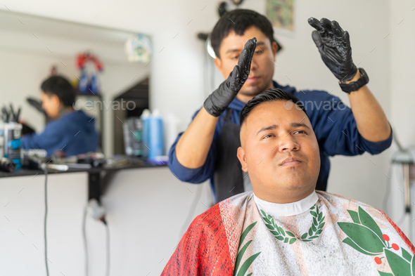 Barber fixing the hair of a latin client using gel Stock Photo by GSR ...