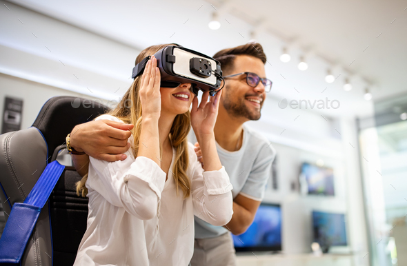 Group of people using virtual reality headset at exhibition, show. VR technology simulation ...