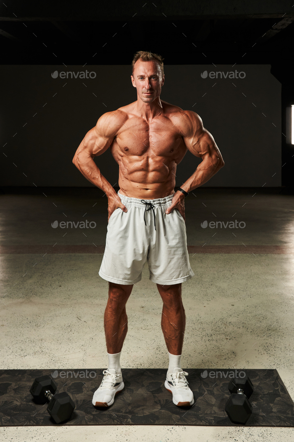 Radiating magnetism, a young, muscular man's muscles command attention ...