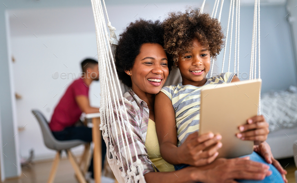 Portrait of happy mother with child using digital tablet for education, fun, game. Technology ...