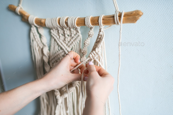 Woman weaves home decor from cotton thread macrame. Macrame panel ...