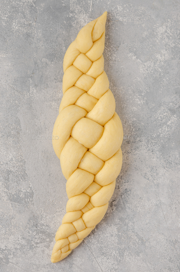 Raw loaf of challah Jewish bread on a light gray background. Top view ...