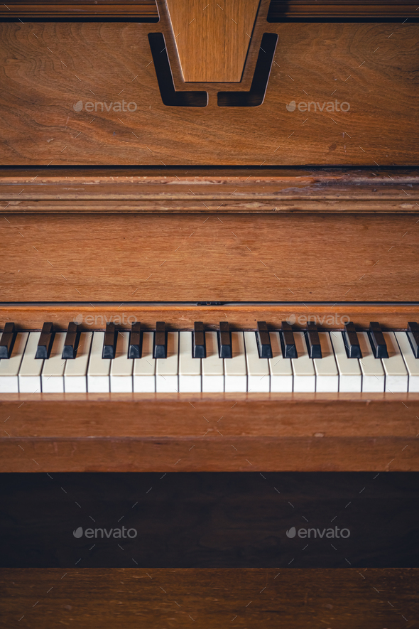 Piano keys on wooden brown musical instrument. Stock Photo by puhimec