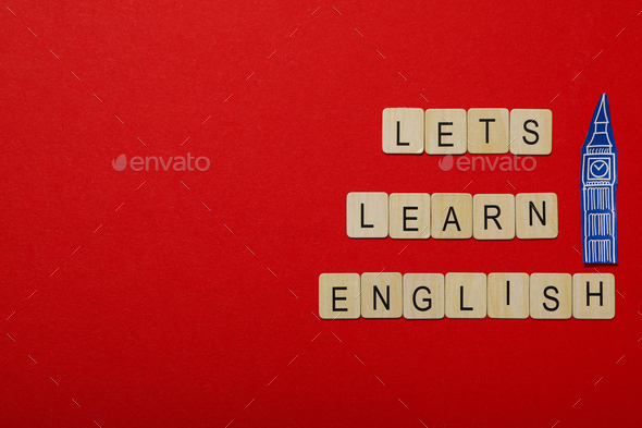 The phrase "let's learn English" on a red background. Stock Photo by ...